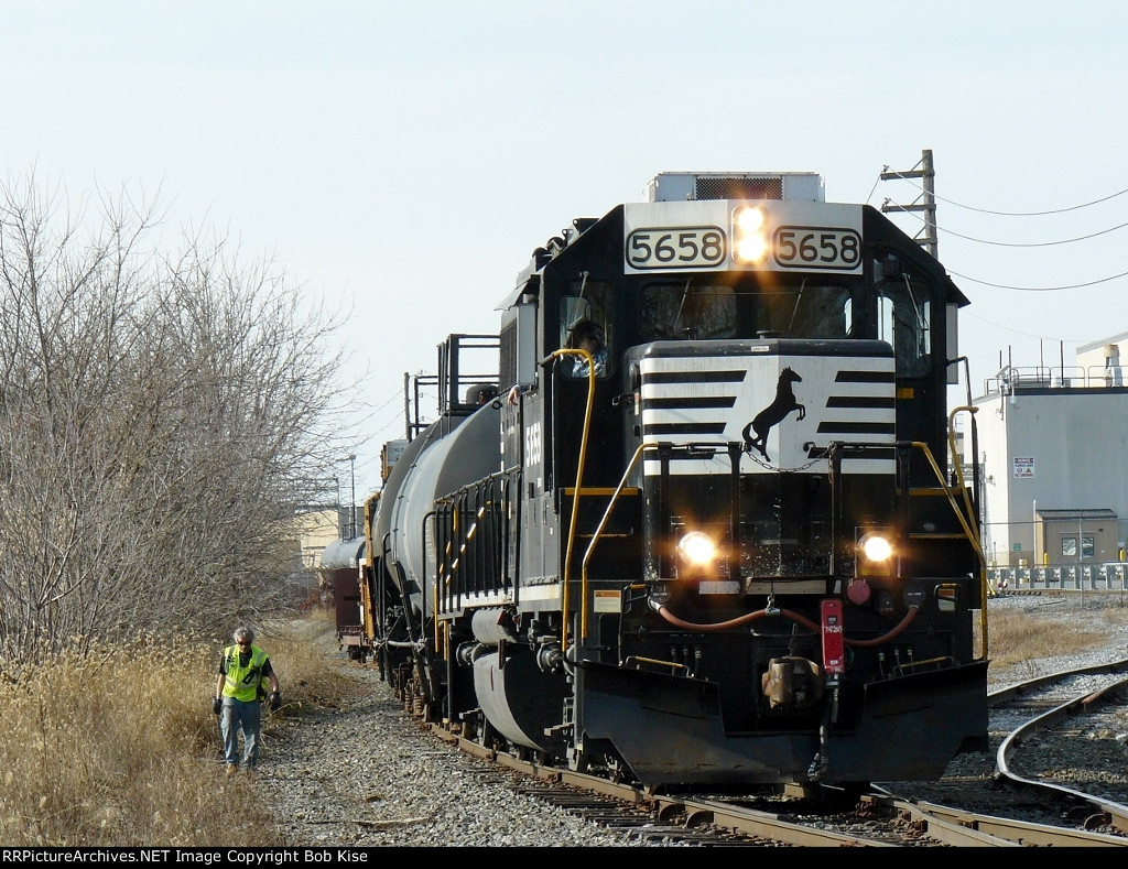 The brakeman walking toward the head end